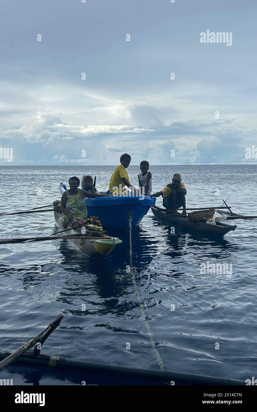 Residents of New Hanover island in their traditional dugout canoes, New ...