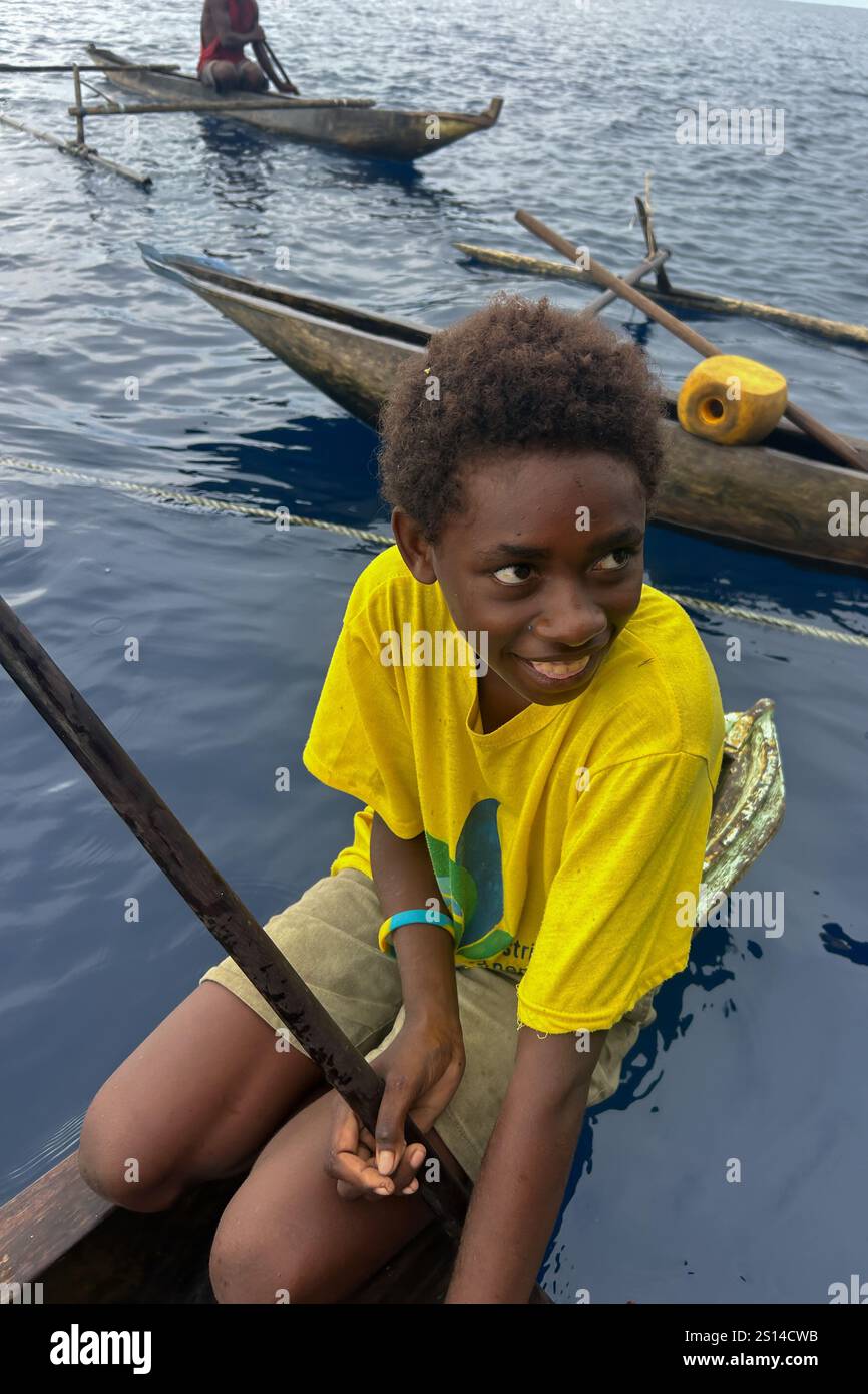 Residents of New Hanover island in their traditional dugout canoes, New ...