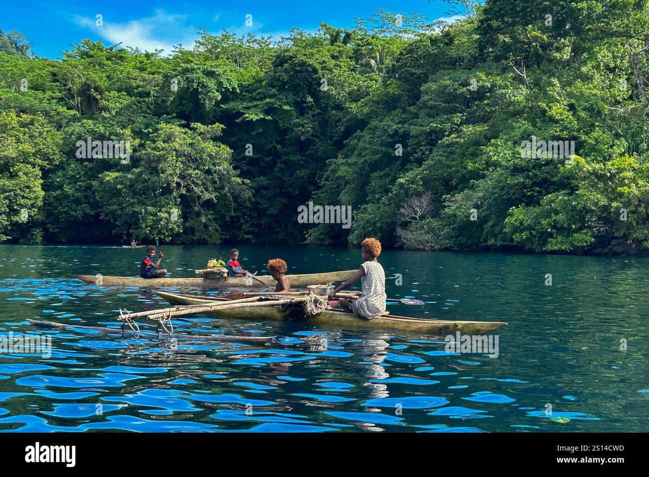 Residents of Vitu Islands in their traditional dugout canoes, Garove ...