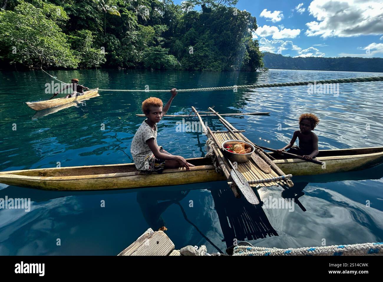 Residents of Vitu Islands in their traditional dugout canoes, Garove ...