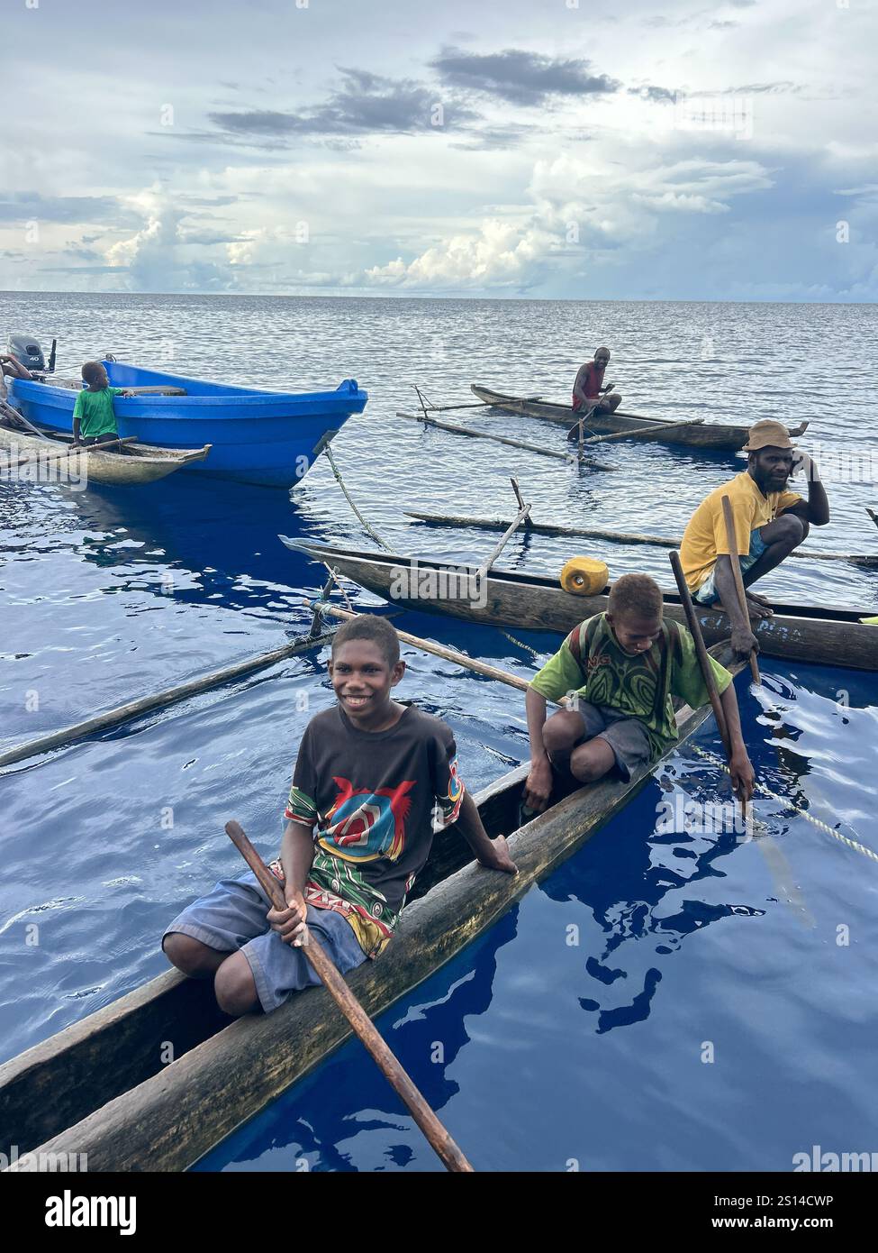 Residents of New Hanover island in their traditional dugout canoes, New ...