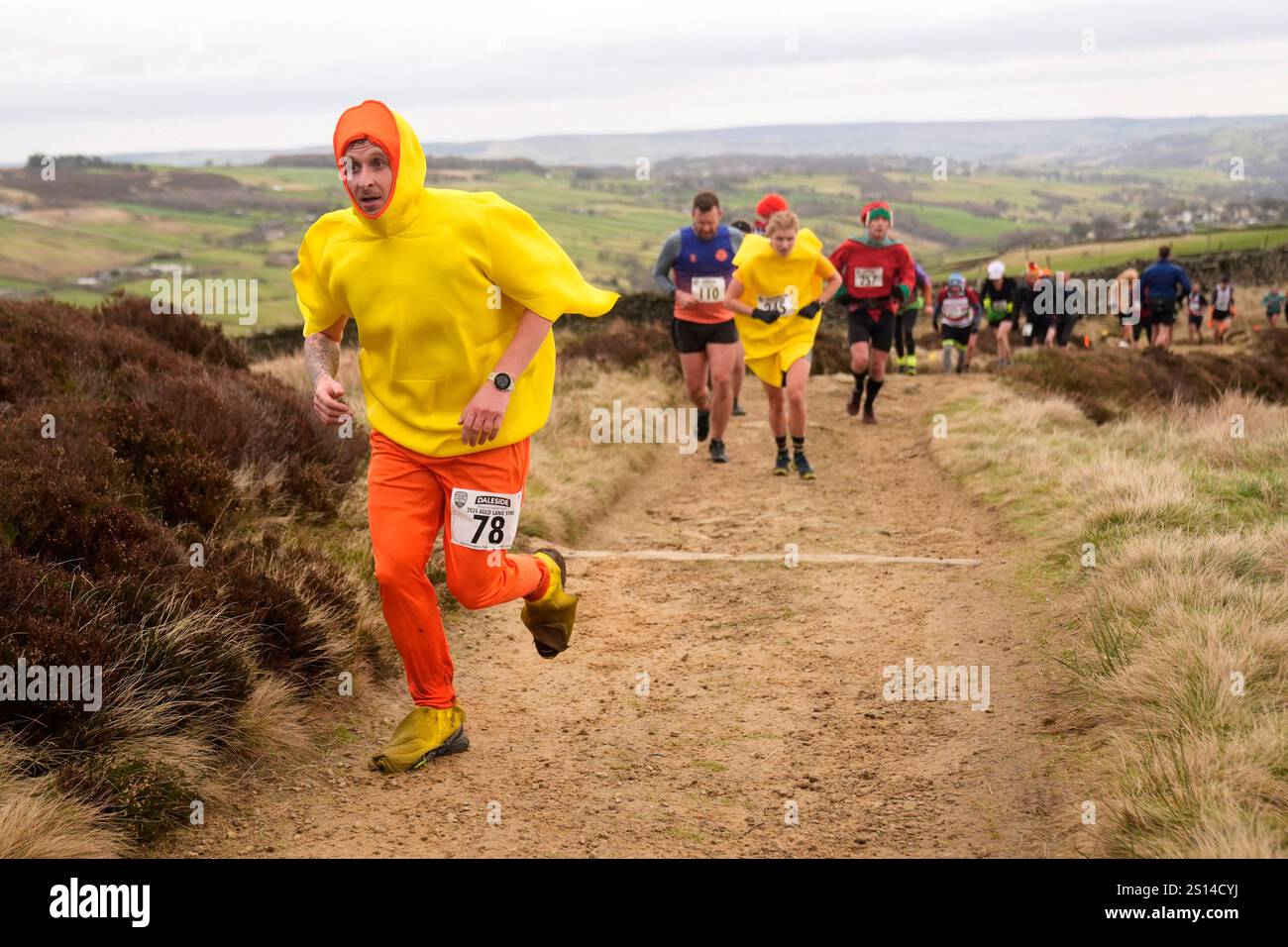 Competitors in fancy dress run across the Pennine tops near Haworth ...