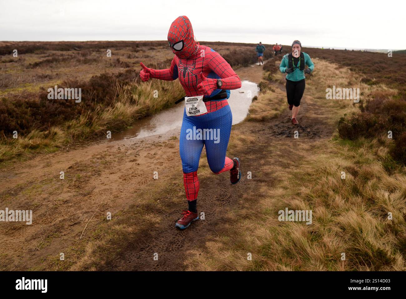 Competitors in fancy dress run across the Pennine tops near Haworth ...