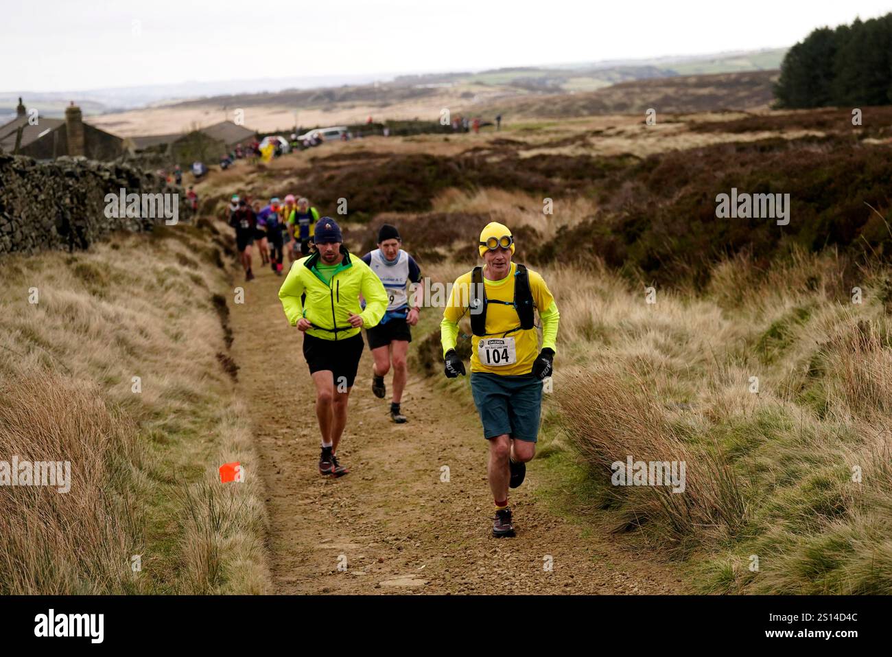 Competitors in fancy dress run across the Pennine tops near Haworth ...