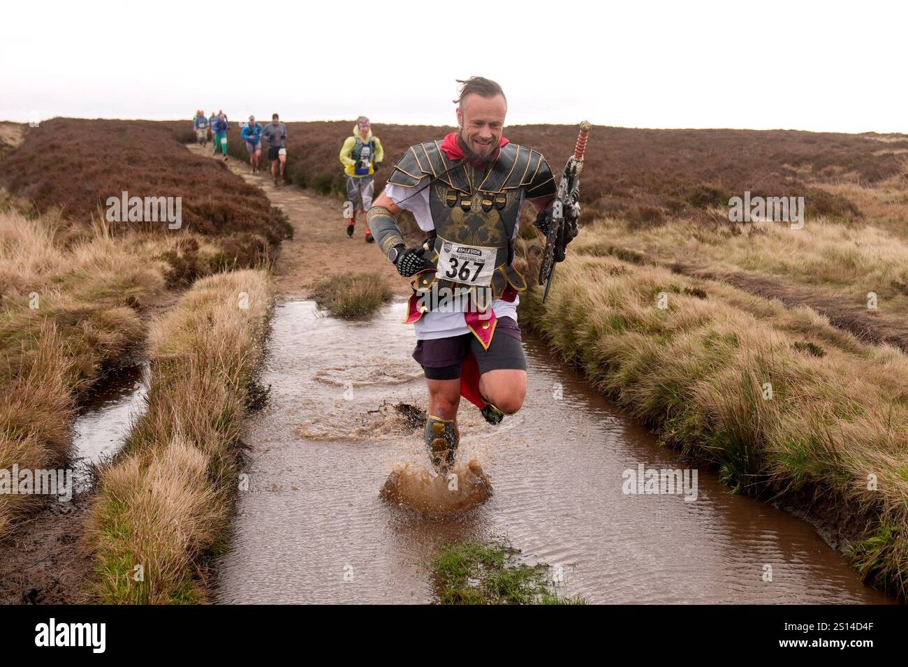 Competitors in fancy dress run across the Pennine tops near Haworth ...