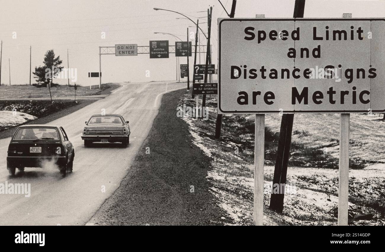 A sign indicating speed limit and distance signs are measured in metric ...