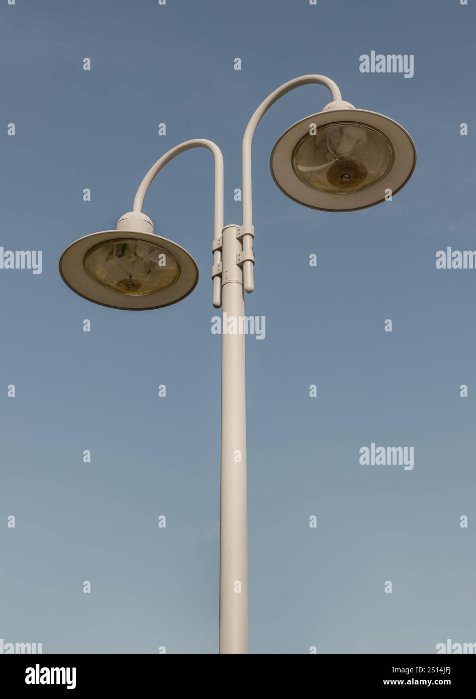Two vintage street lamps on White metal lamp post against the ...