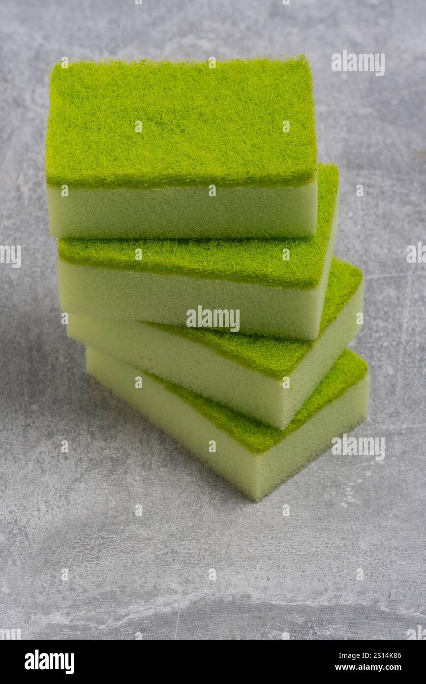 Stack of green sponges for cleaning on a grey background Stock Photo ...