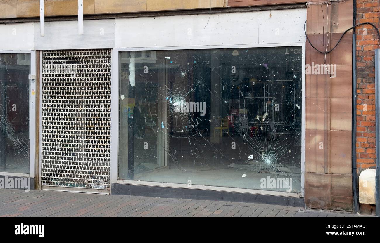 high street vandalism, smashed glass shop front window, urban decay ...
