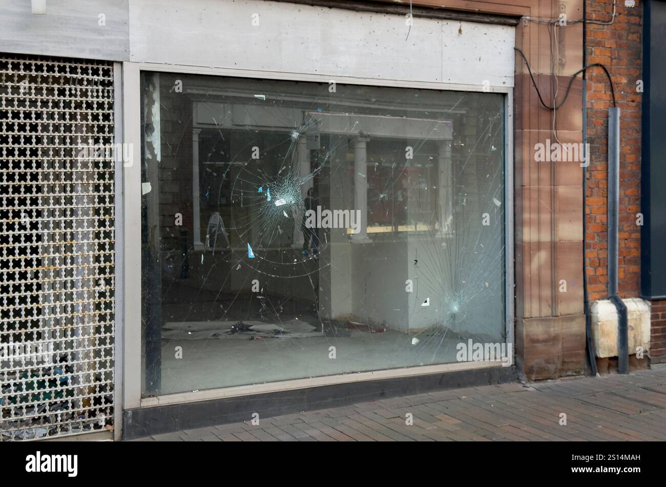 high street vandalism, smashed glass shop front window, urban decay ...