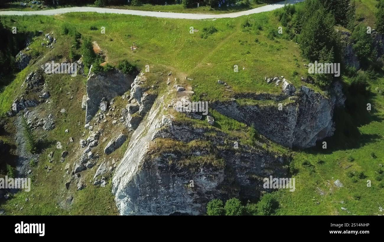 A scenic Rocky outcrop is surrounded by a dense forest landscape that ...
