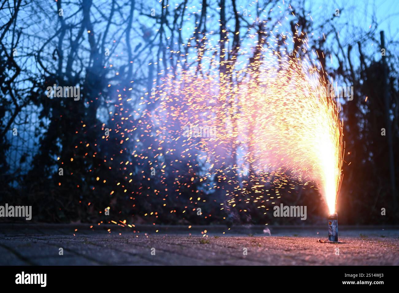 Leer, Germany. 31st Dec, 2024. As a firework fountain ignites, the ...