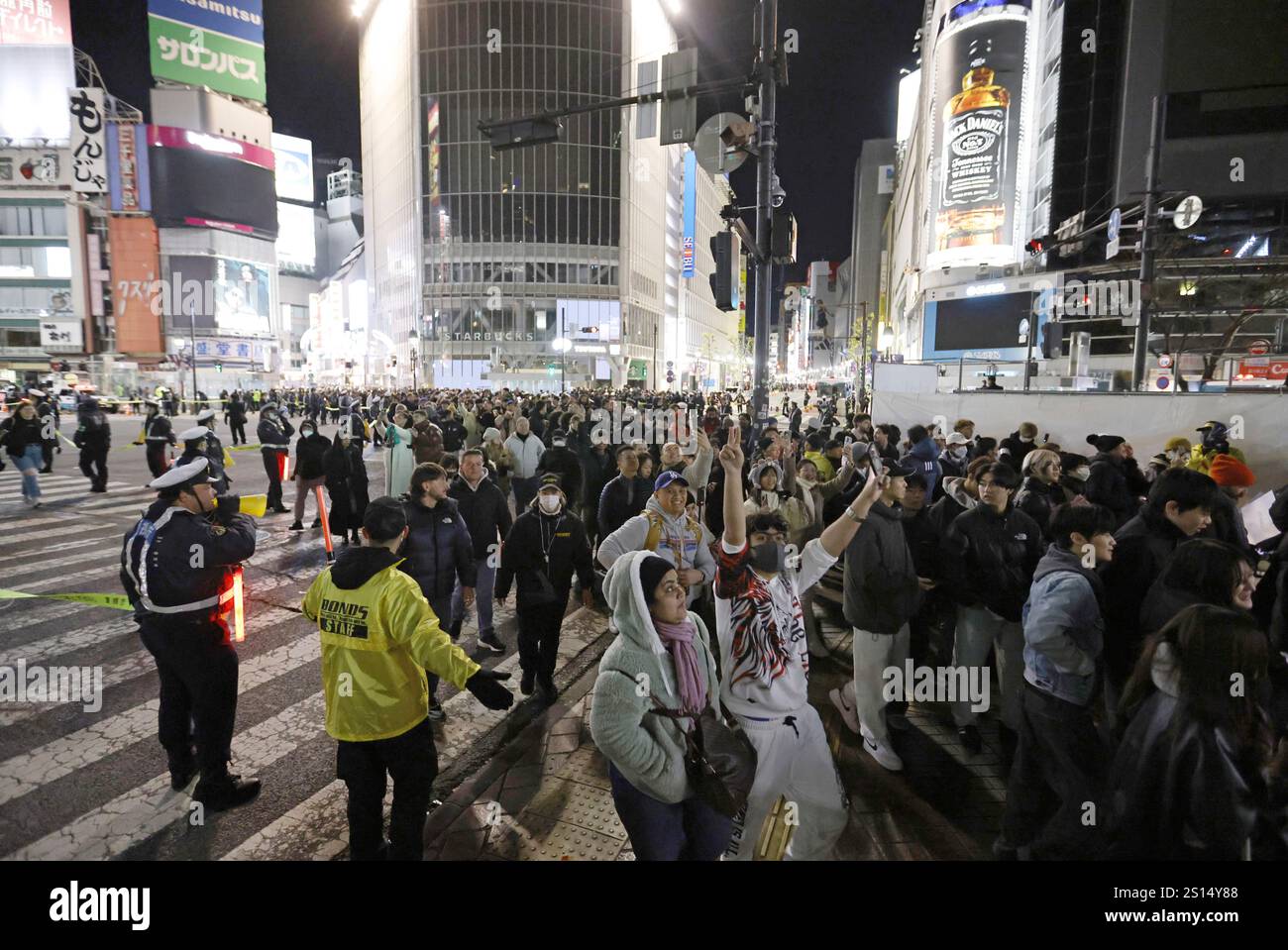 On January 1, 2025, many pedestrians reach the New Year around the ...