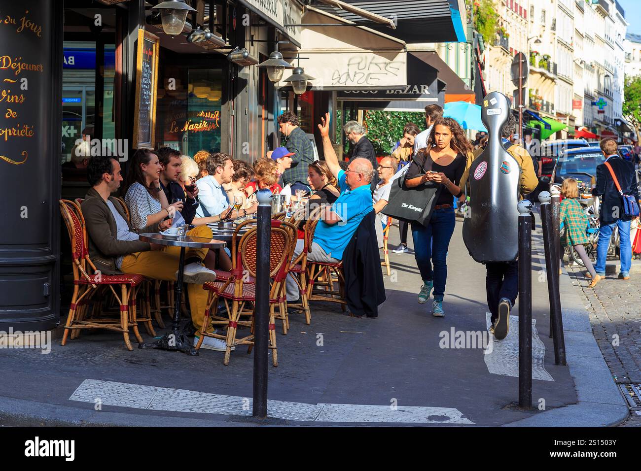 PARIS, FRANCE - MAY 12, 2015: Residents relax in one of the many cafes ...