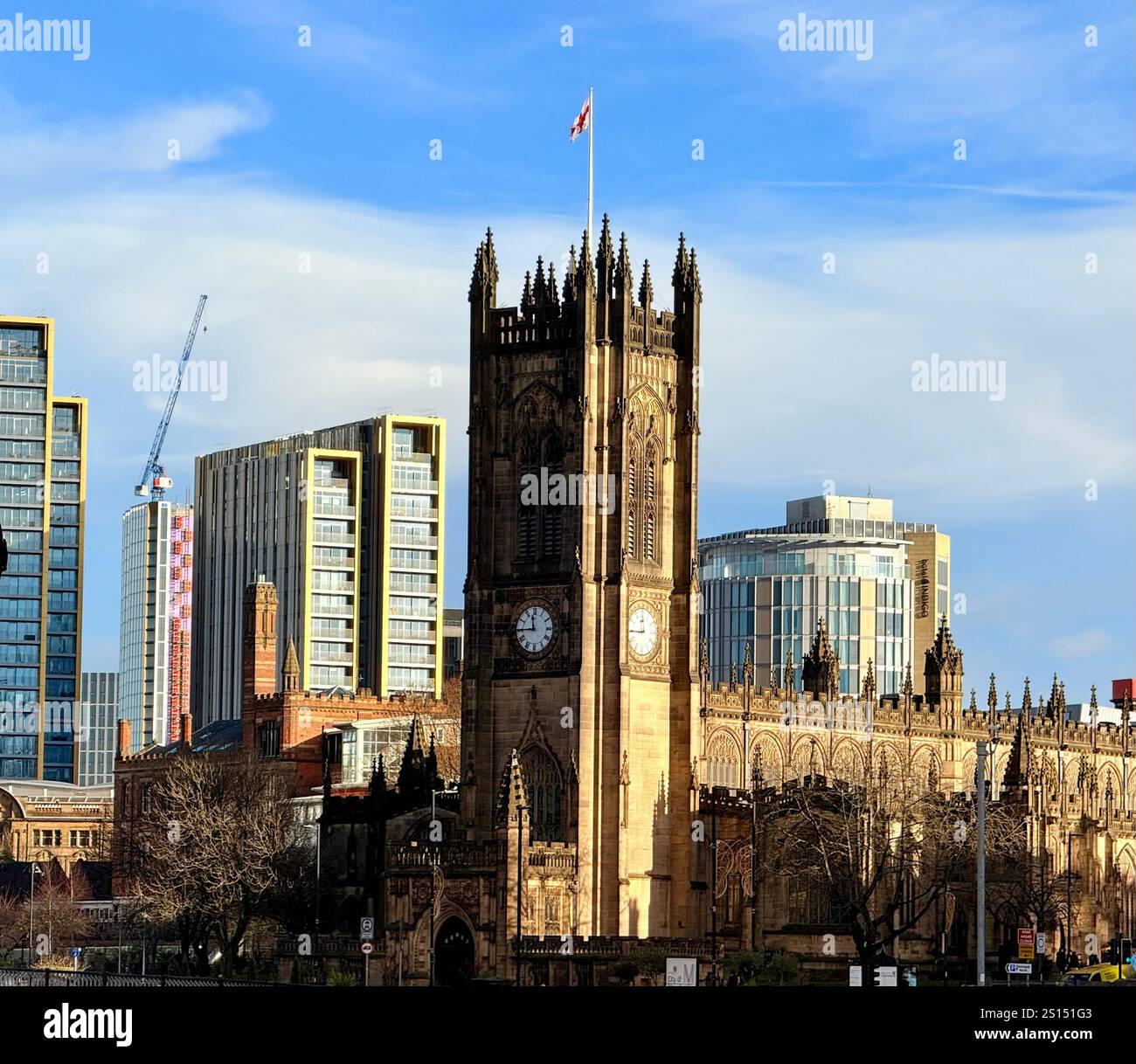 Manchester Cathedral surrounded by modern high rise buildings and ...