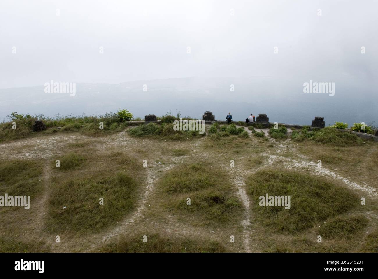 Tourists explore the grounds and hillside at the Bokor Hill Station hotel casino ruins, Cambodia ...