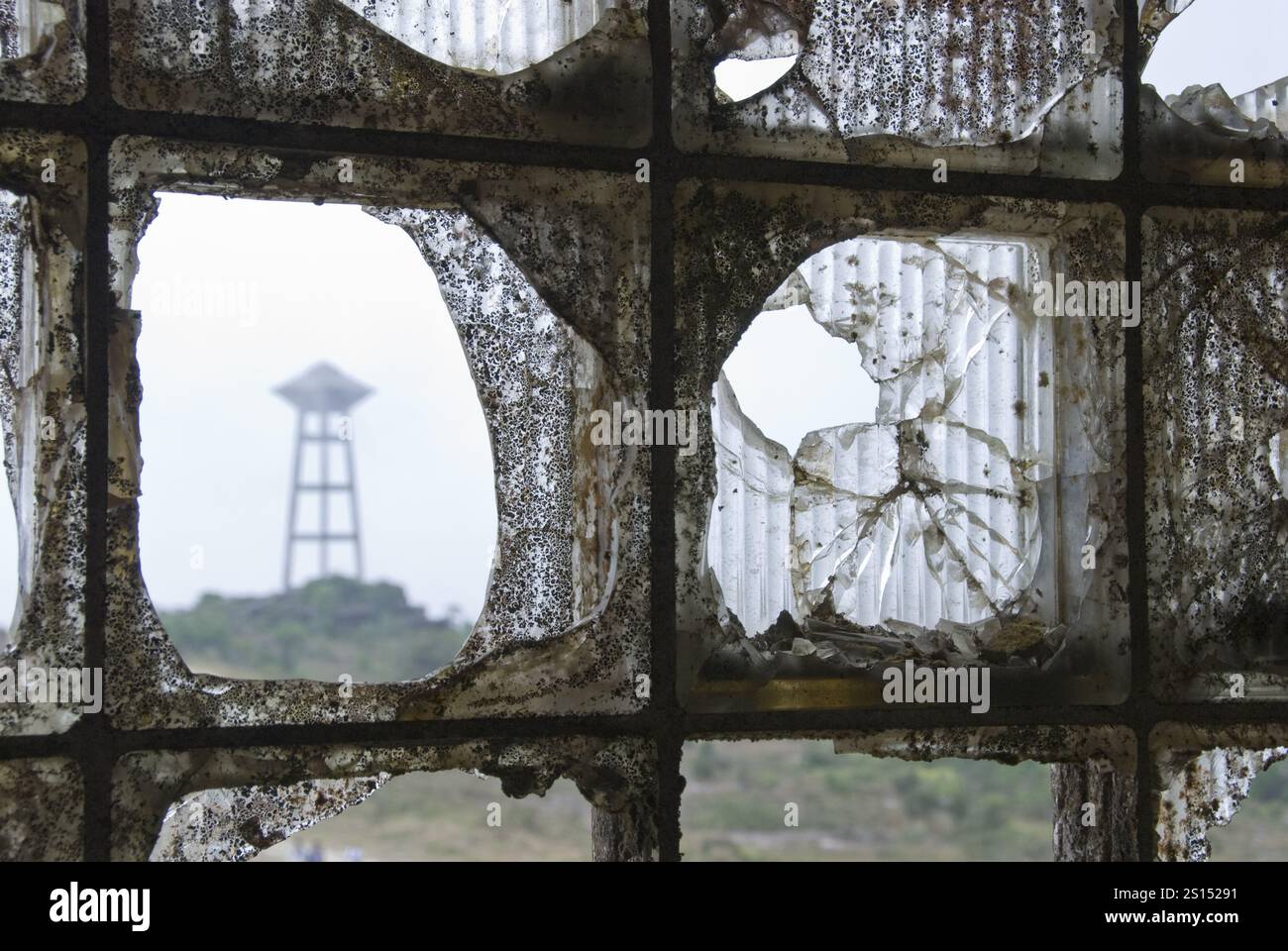 Broken windows with view of water tower at the ruins of the Bokor ...