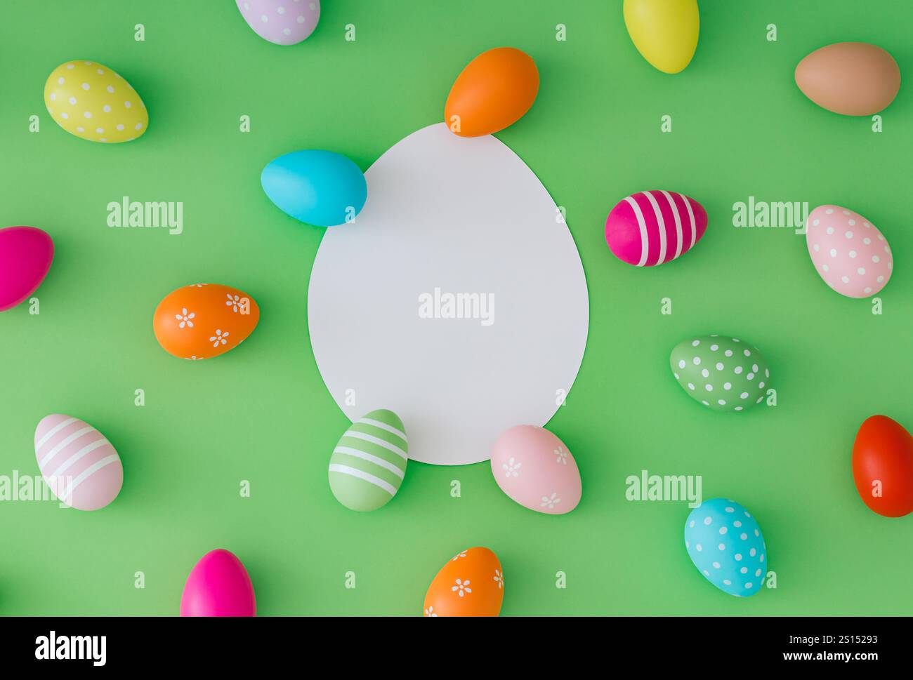 Spring pattern made of colorful Easter eggs on pastel green background ...
