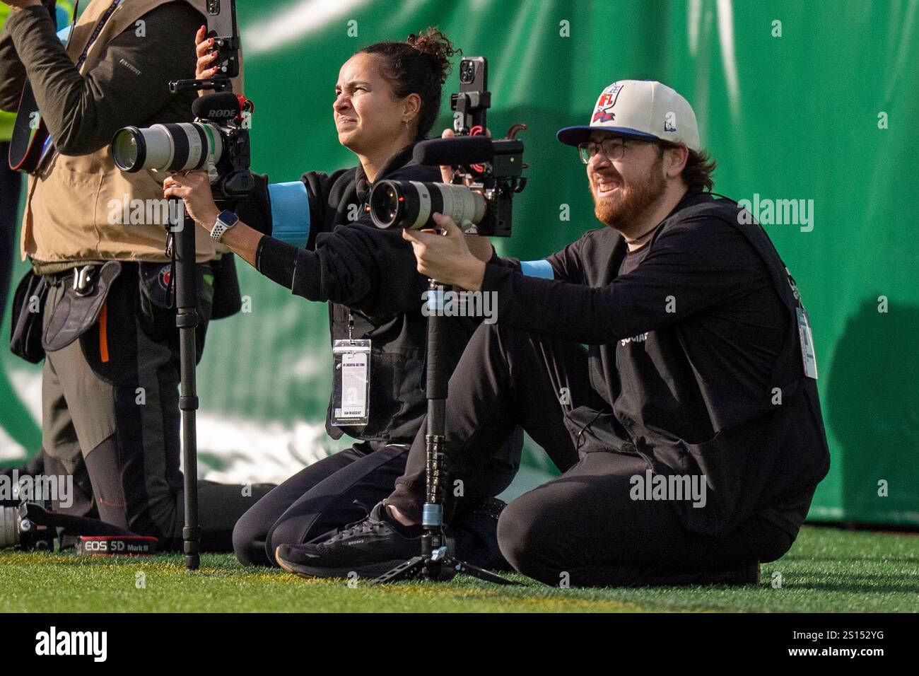 NFL content creator/mentor Denis Kennedy, right, shoots works alongside ...
