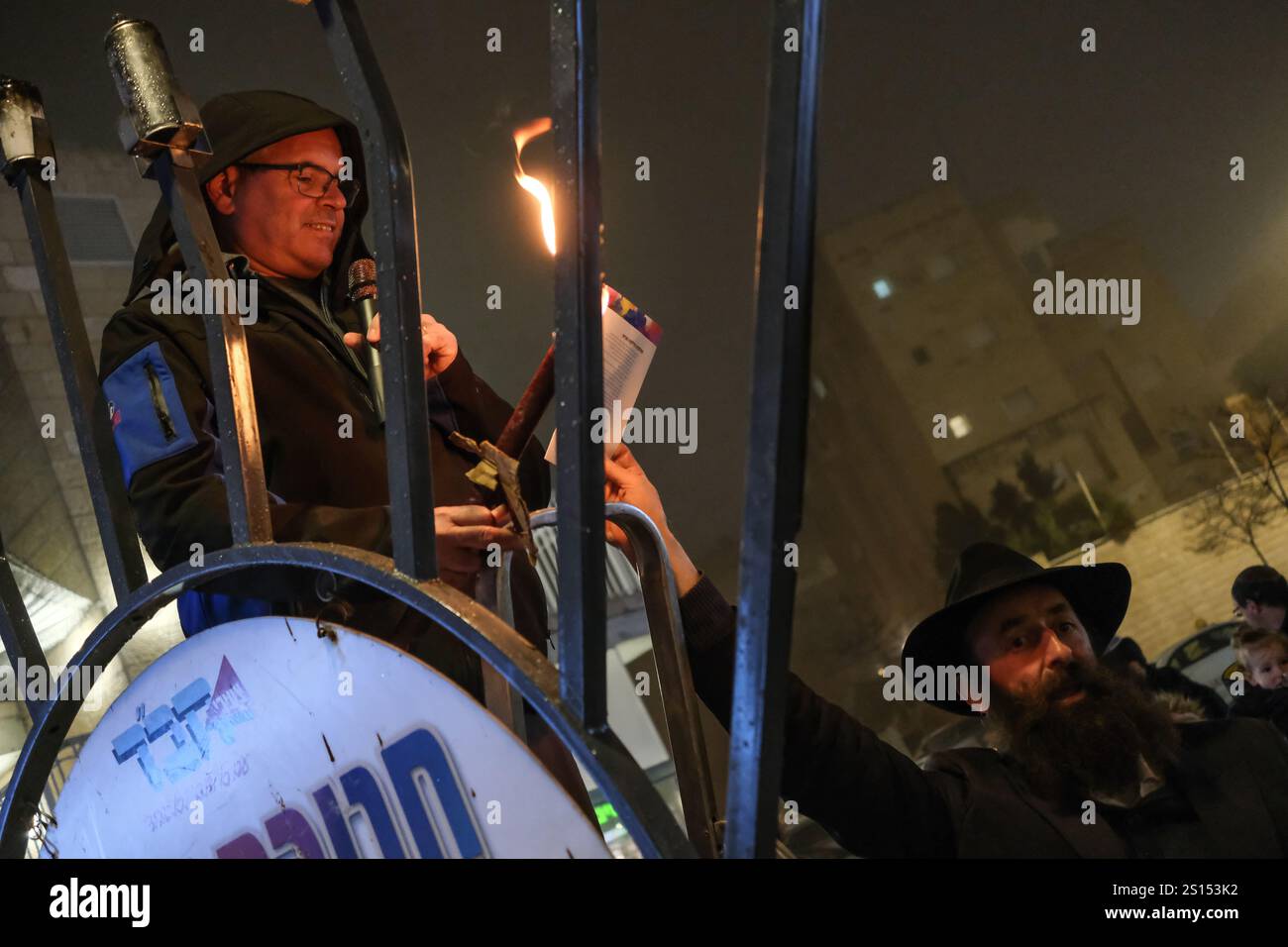 Jerusalem, Israel. 31st Dec, 2024. A Jewish man lights seven candles on ...