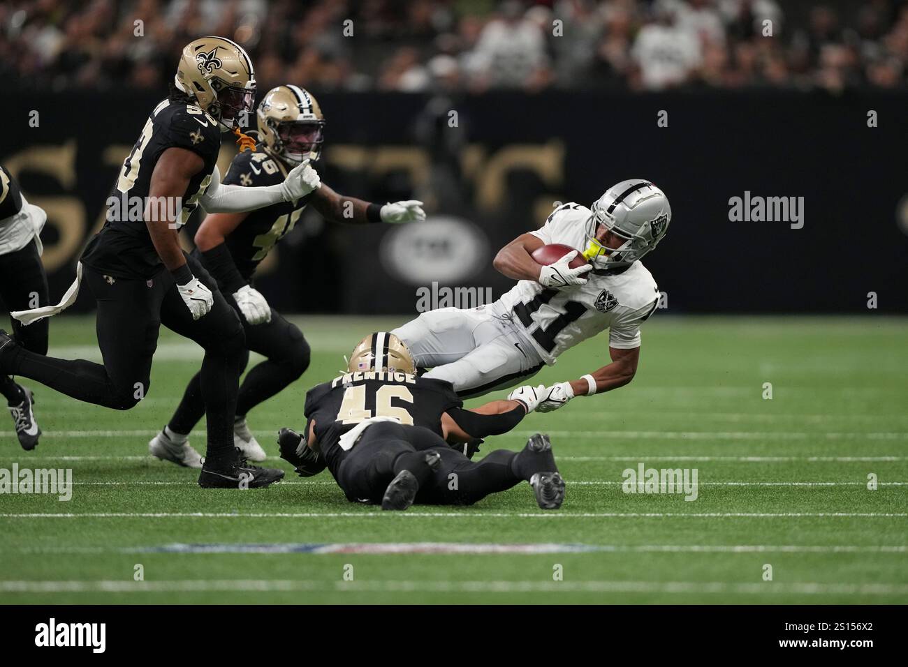 Las Vegas Raiders Tre Tucker (11) is tackled by New Orleans Saints Adam ...