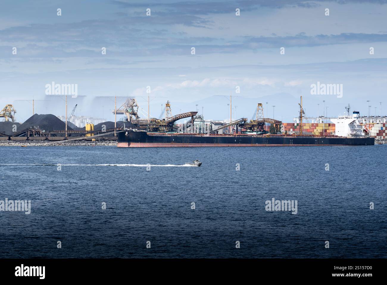 Coal port with conveyer belts loading coal onto freighters for export ...