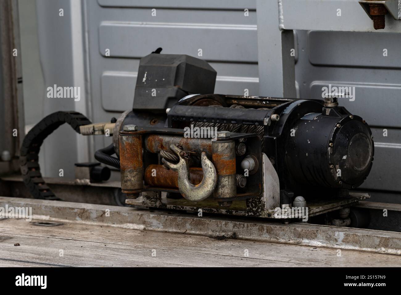 A heavy-duty winch system is positioned on metal decking, showcasing ...