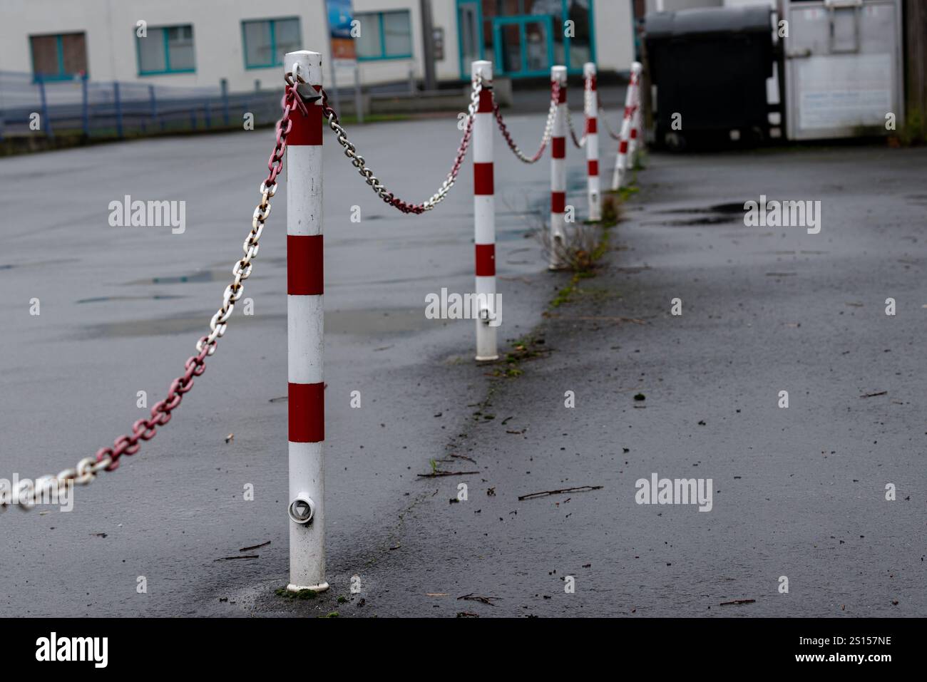 Red and white striped posts connected by chains are visible in an empty ...
