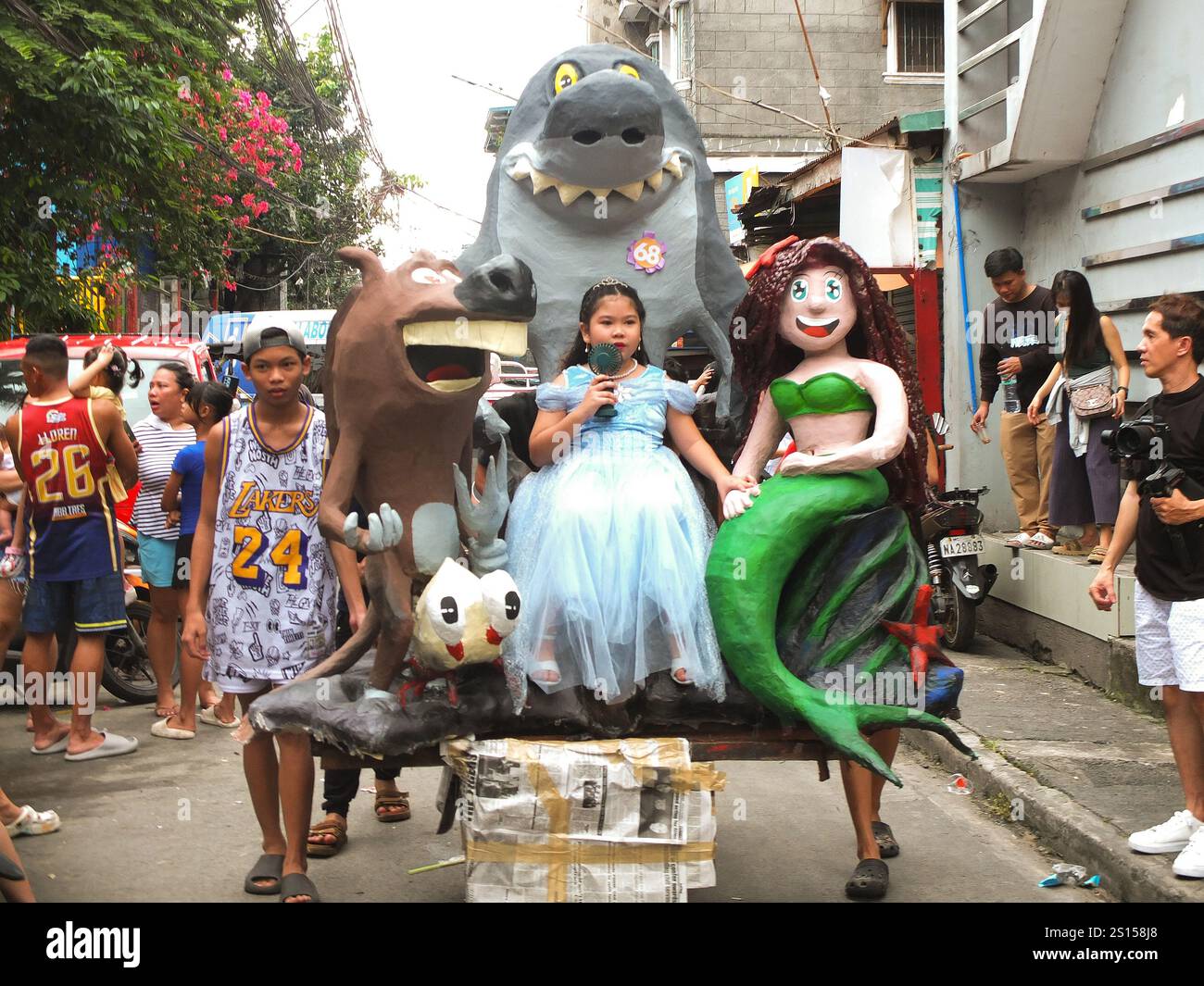 Malabon, Philippines. 31st Dec, 2024. A Jabberjaw or a comedic shark character effigy is paraded ...