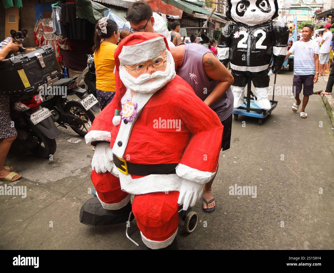 Malabon, Philippines. 31st Dec, 2024. A Santa Claus effigy is paraded ...