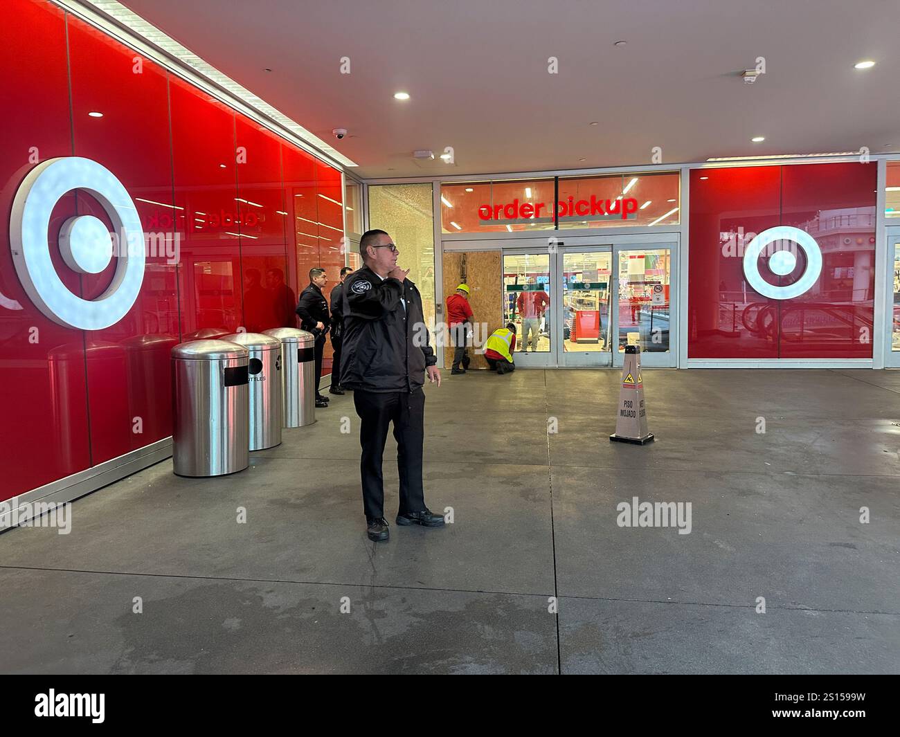 A security guard stands outside a Target store after two security ...