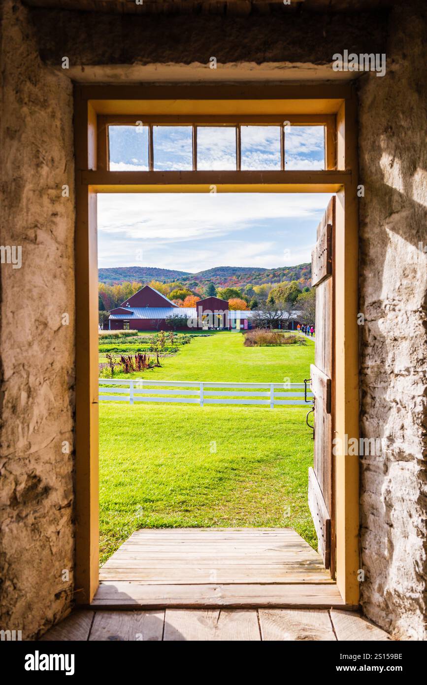 Wooden door in stone building looking out on view of colorful fall ...