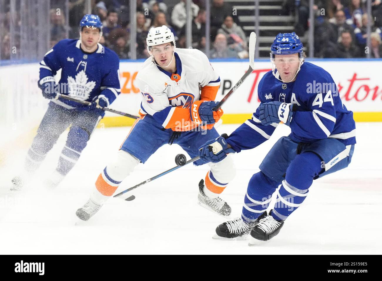 New York Islanders Mathew Barzal (13) plays the puck past Toronto Maple ...