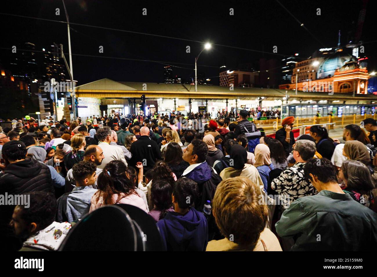 Melbourne, Australia. 01st Jan, 2025. A large crowd gathers around ...
