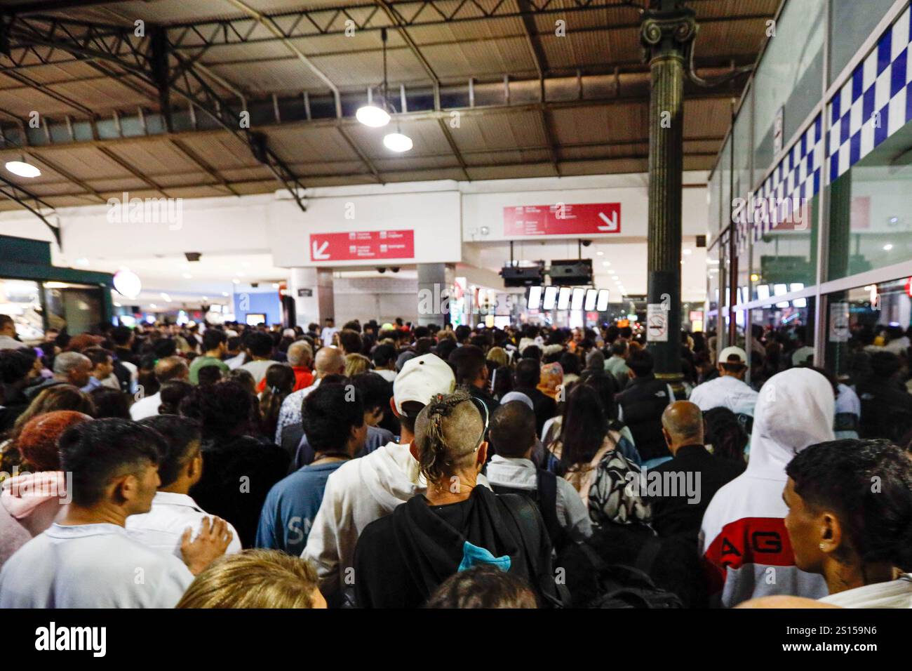 Melbourne, Australia. 01st Jan, 2025. A large crowd gathers around ...