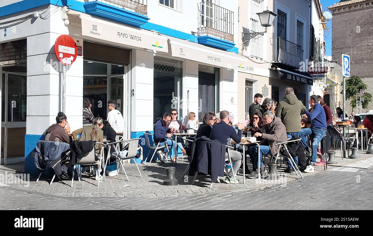 Local Spanish people in Seville, sitting outside for a drink and meal ...