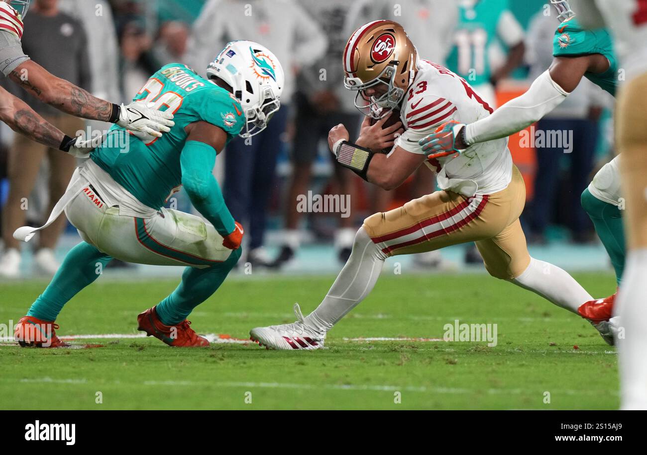 San Francisco 49ers quarterback Brock Purdy (13) runs as Miami Dolphins ...