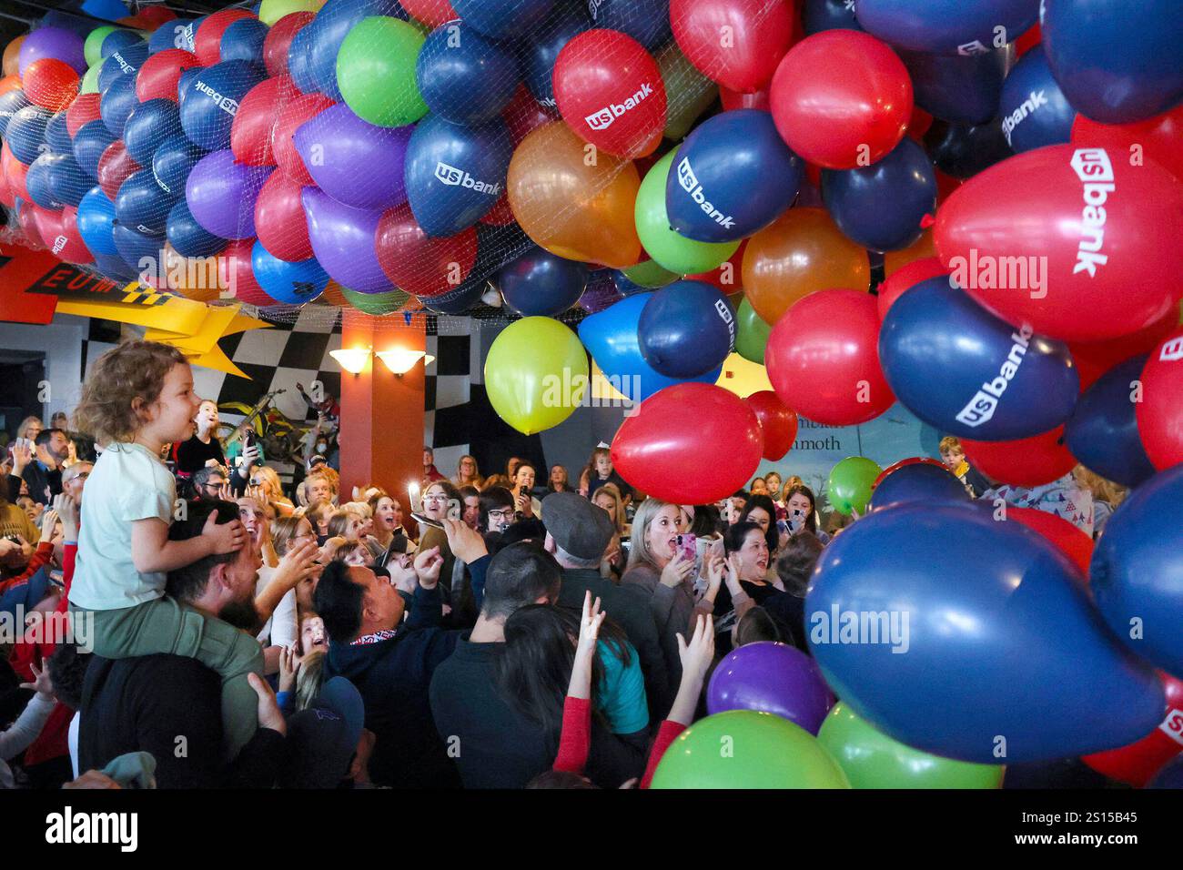 Marina Bailey, 5, watches from her father's shoulders, Matthew Bailey ...