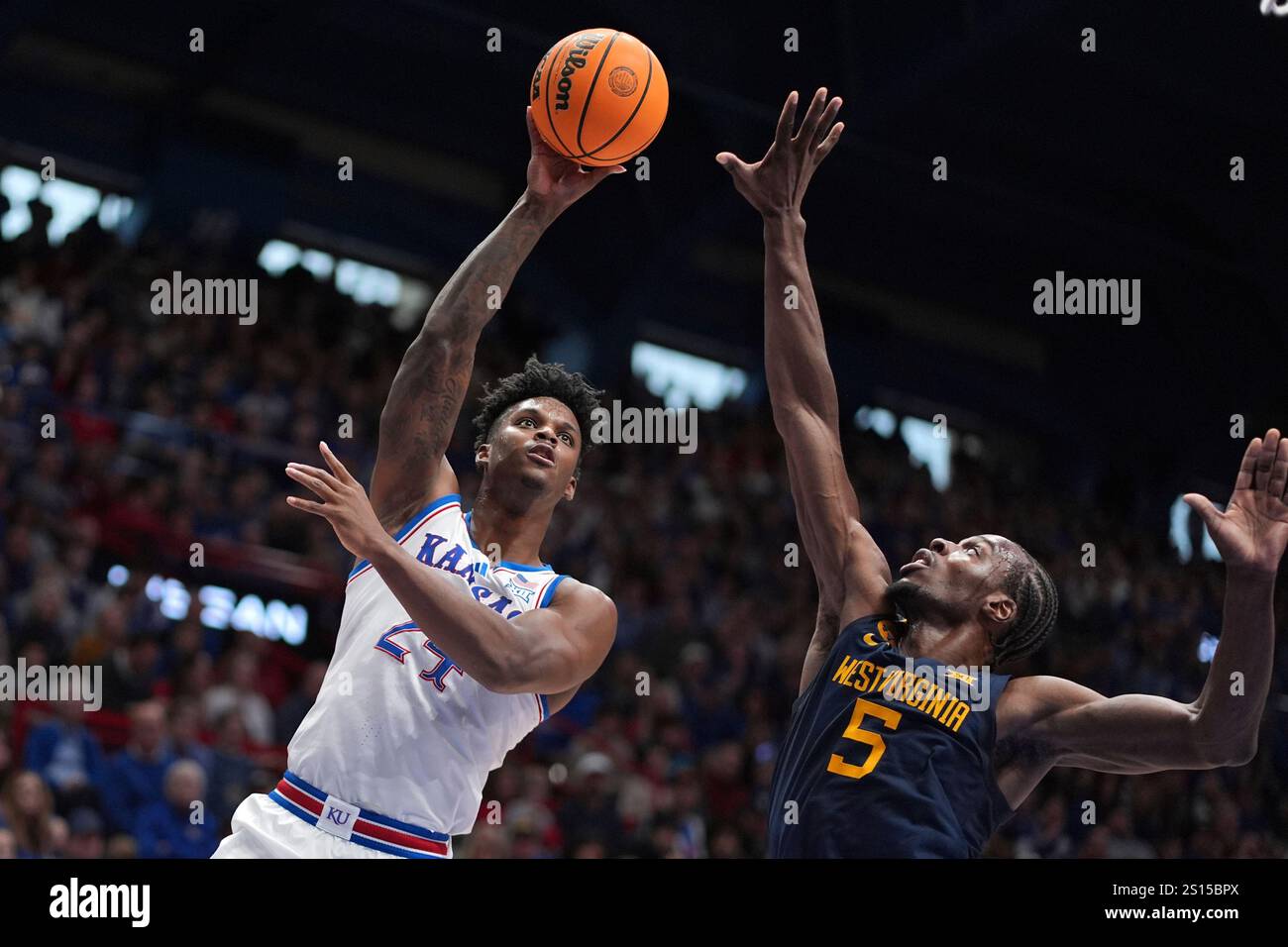 Kansas forward KJ Adams Jr. shoots over West Virginia guard Toby Okani ...