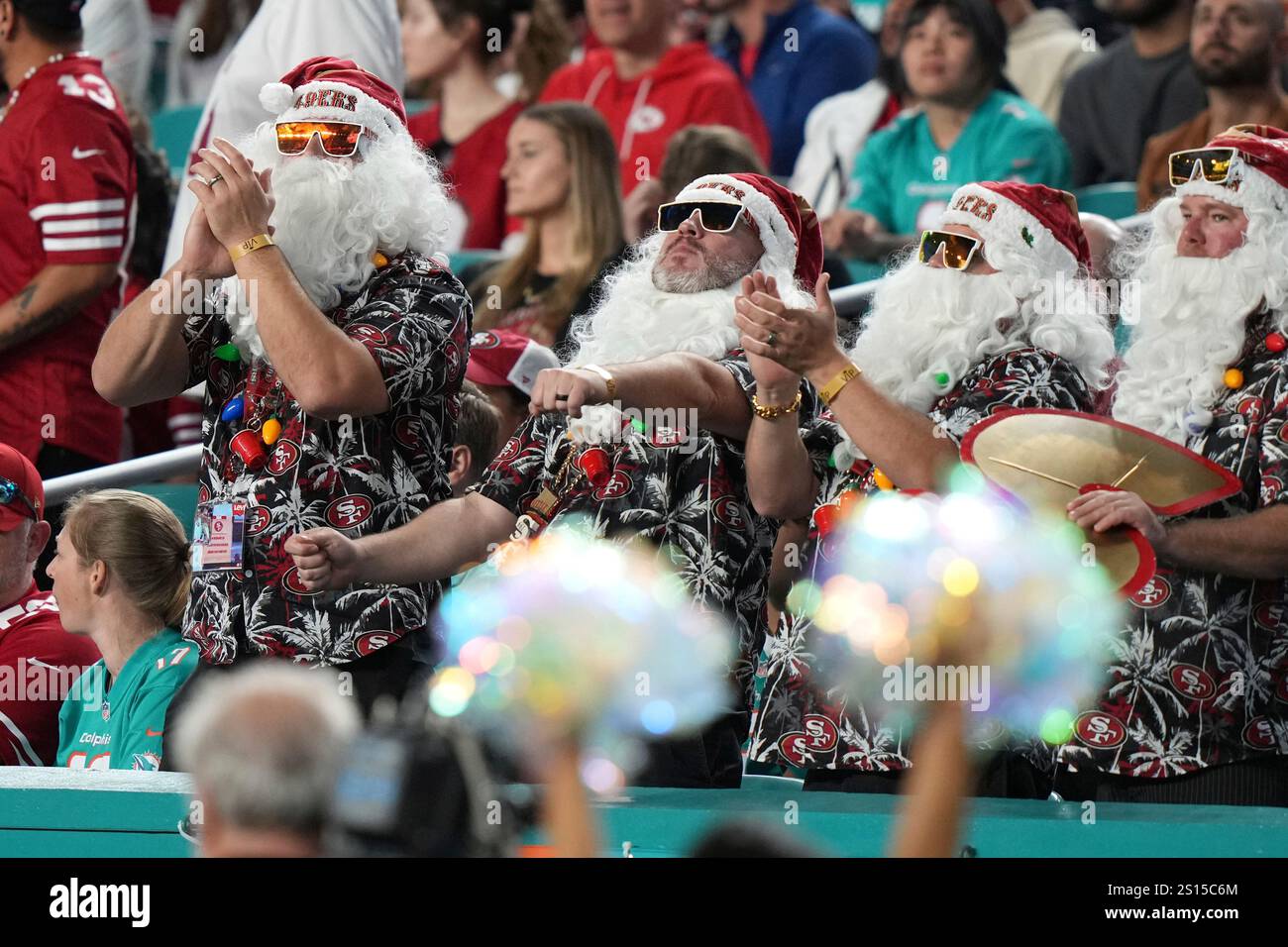 San Francisco 49ers fans dressed in Santa Claus hats and beards cheer ...