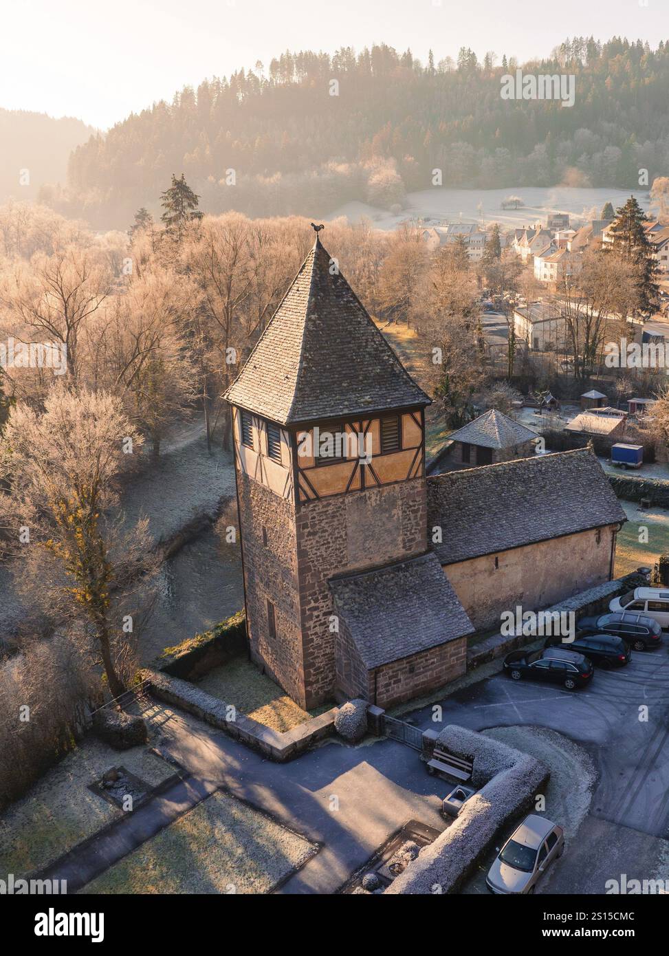 Historic half-timbered church tower in the village, surrounded by ...