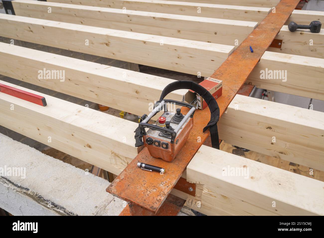 Control unit on an iron beam between wooden beams on a construction ...
