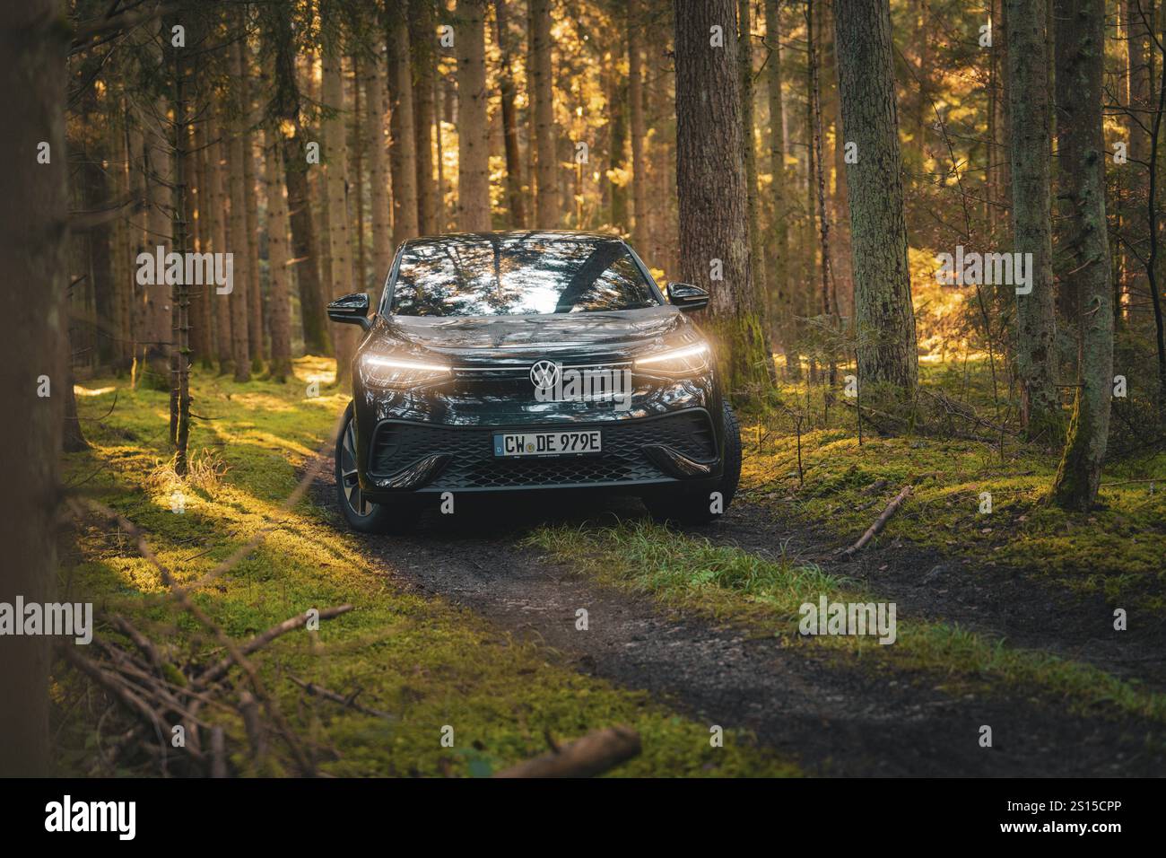 Car driving along a wooded path in a warm autumn atmosphere, car ...