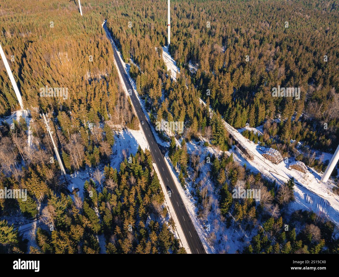 Aerial view of wind power and road in snowy forest, Seewald, Black ...