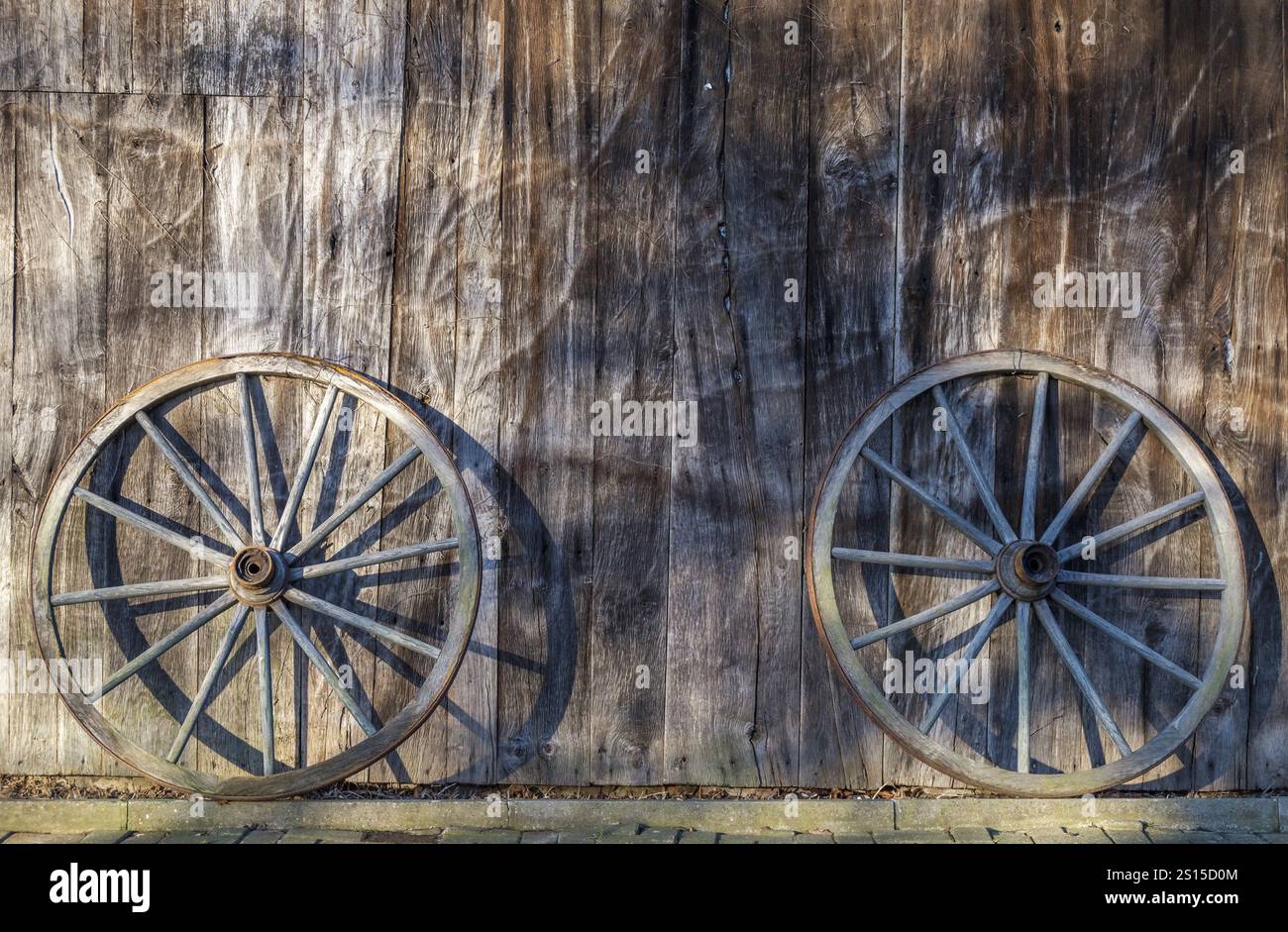 Two wagon wheels leaning against a barn wall, Duestermuehle, Legden ...