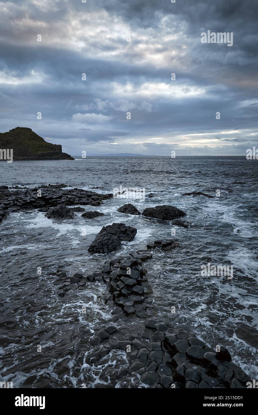 Rocky coast with black basalt columns, coastline, dusk by the sea ...