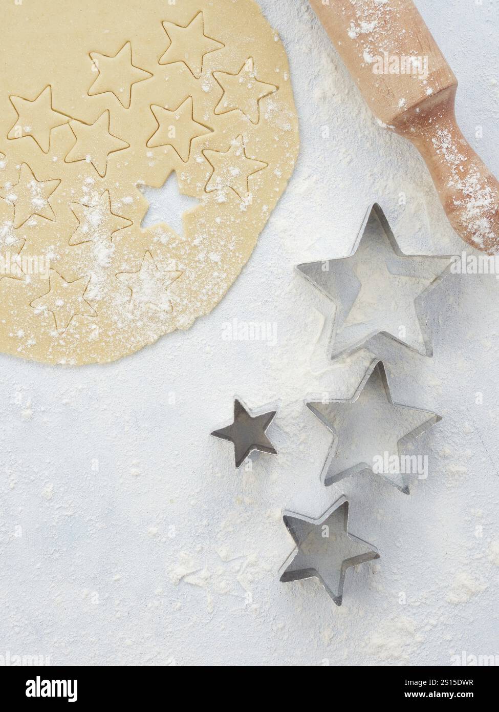 Baking at home, pastry dough with star-shaped cutters of different ...