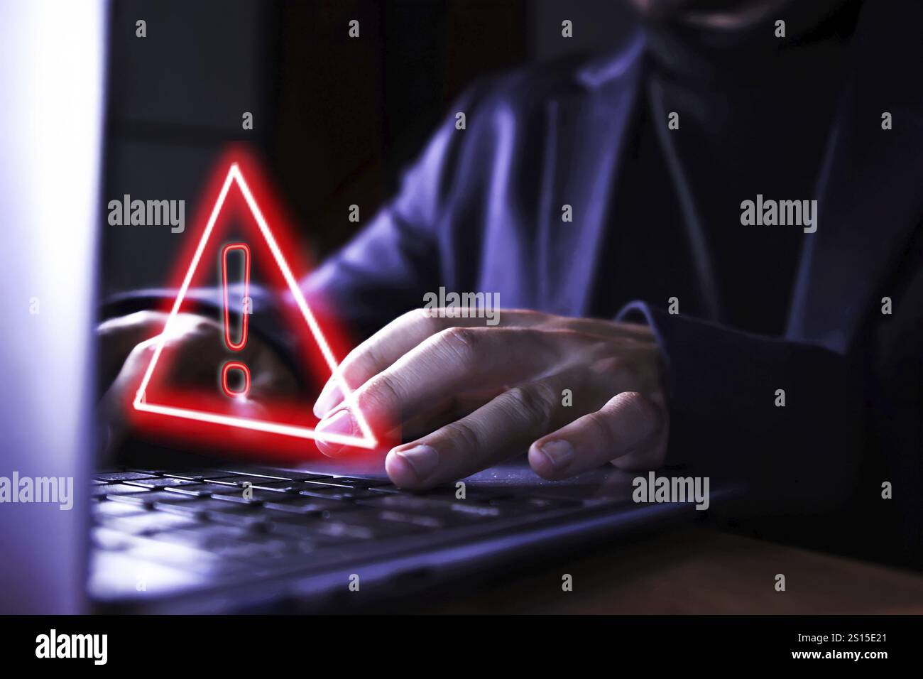 Hands of a businessman using the computer on fraudulent pages. Caution ...