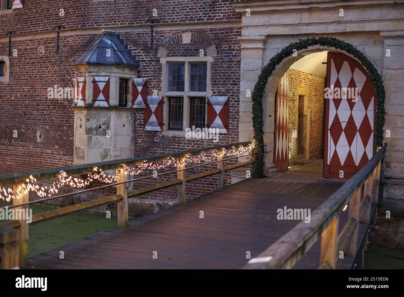 Castle bridge with lights leads to a large entrance gate, Rasfeld ...