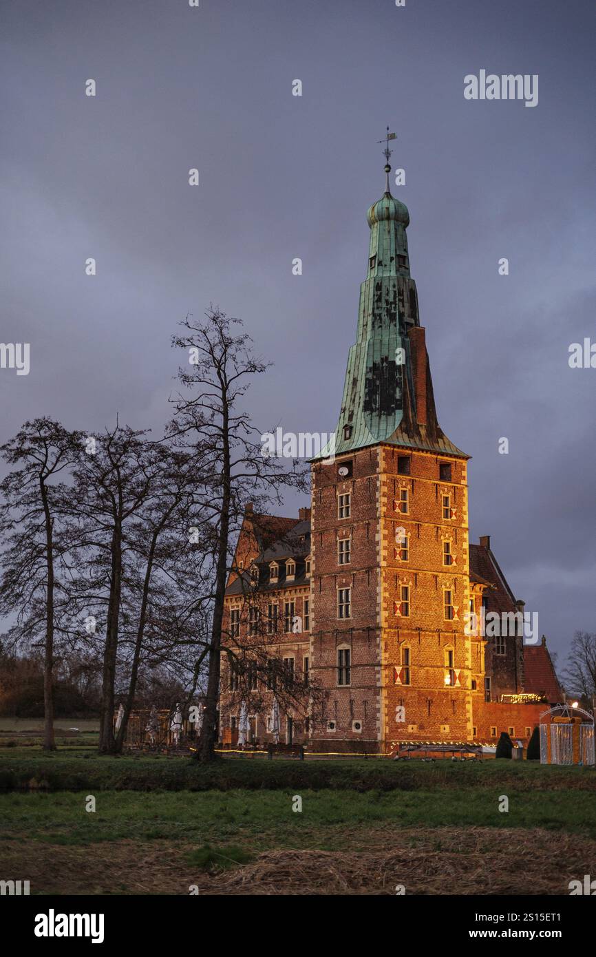 A tall tower of a castle, dramatically illuminated, rises against a ...